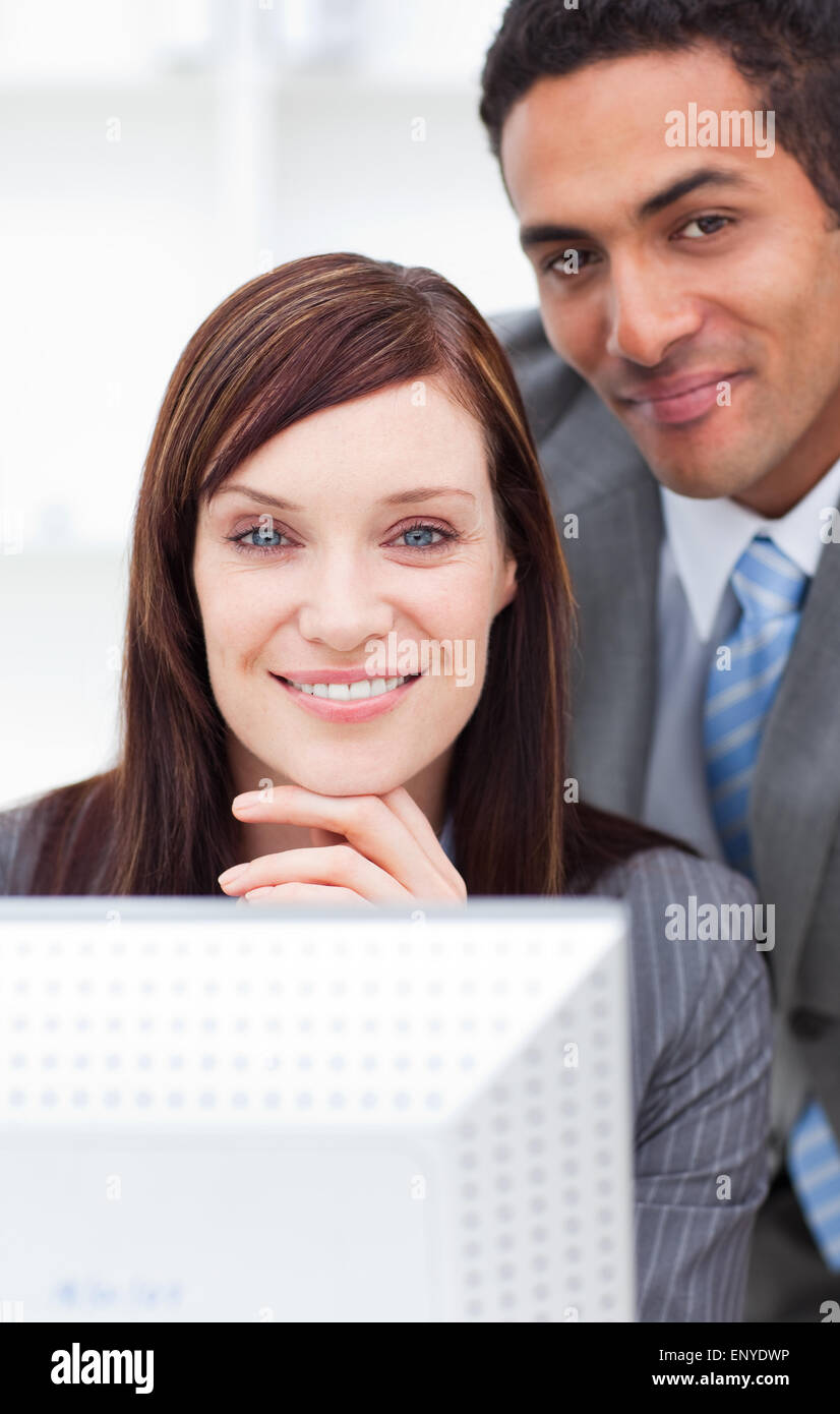 Two smiling colleagues working at a computer Stock Photo - Alamy