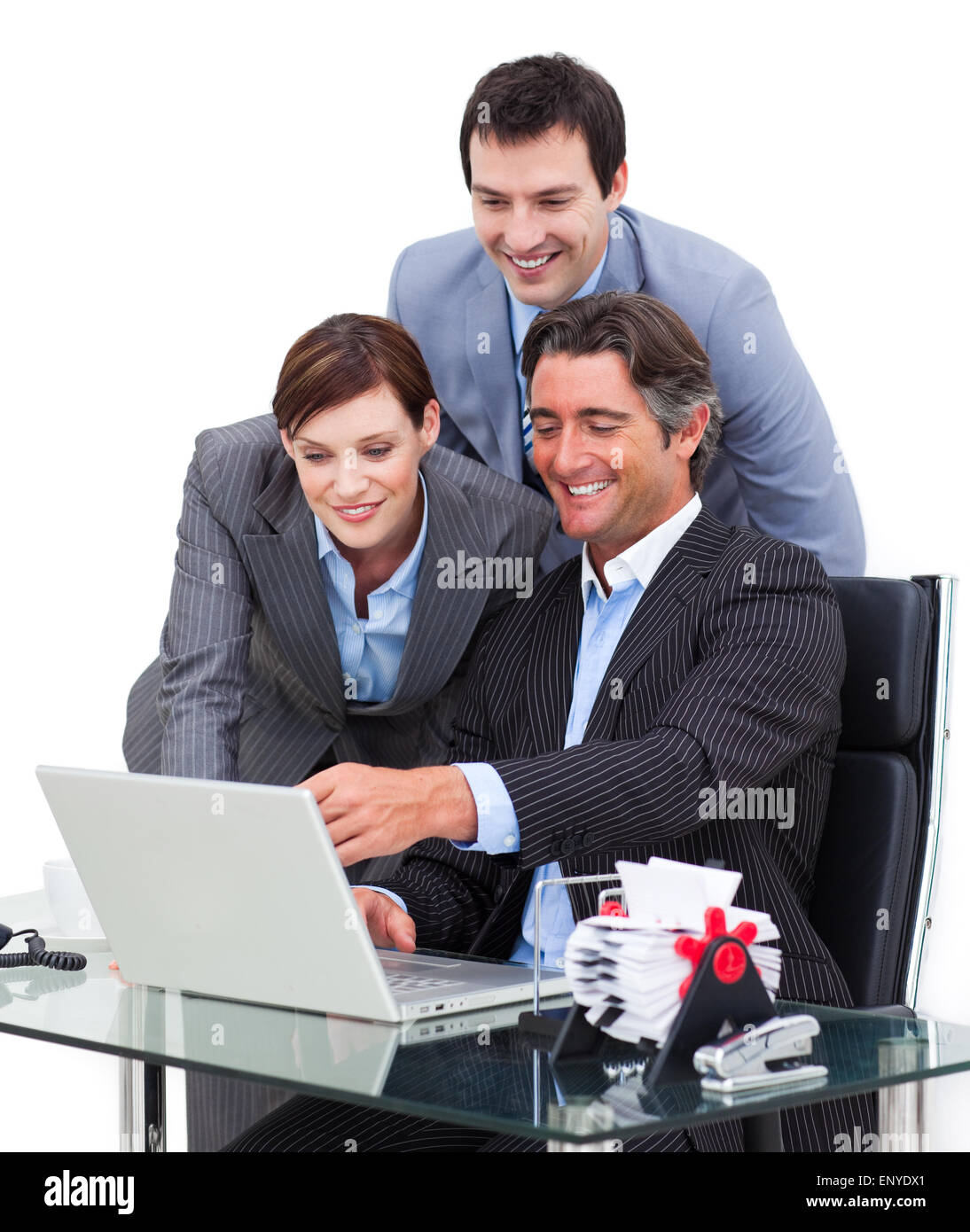 Enthusiastic business team working at a computer against a white ...