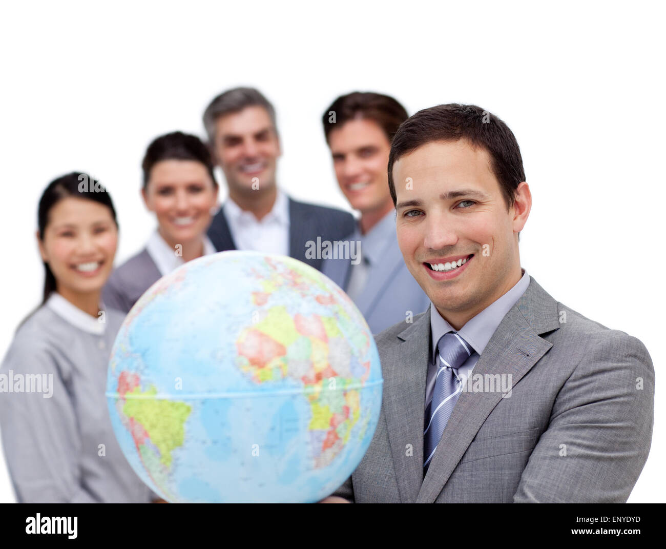 Victorious business team holding a terrestrial globe against a white ...