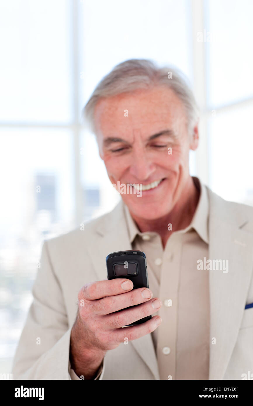Senior manager sending a text Stock Photo - Alamy