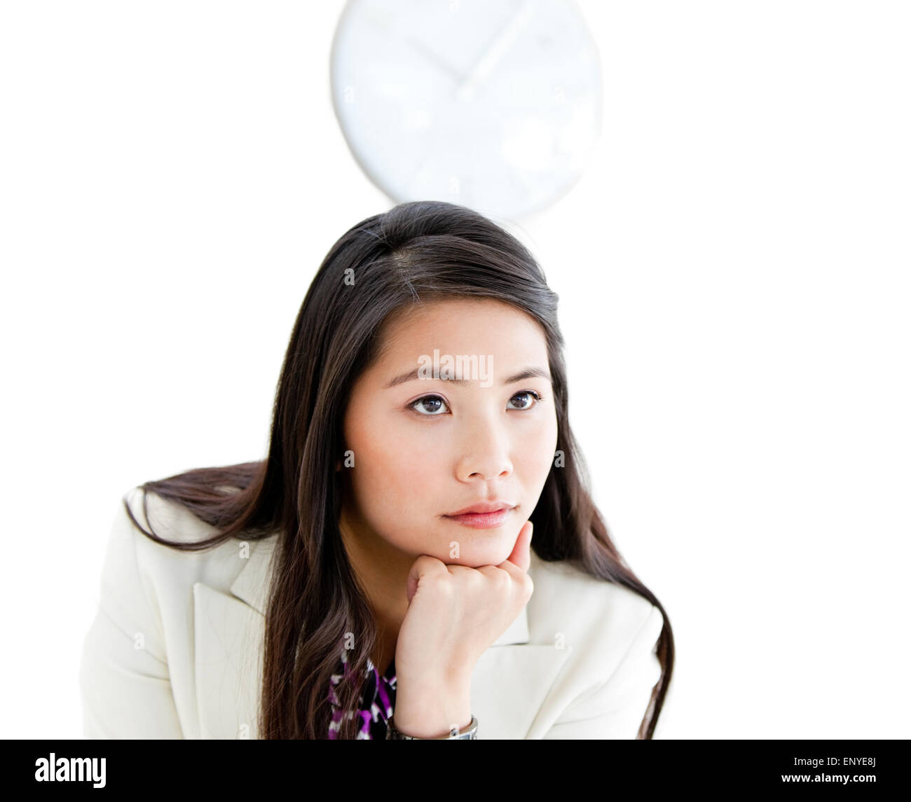 Portrait of a pensive Asian businesswoman against a white background ...