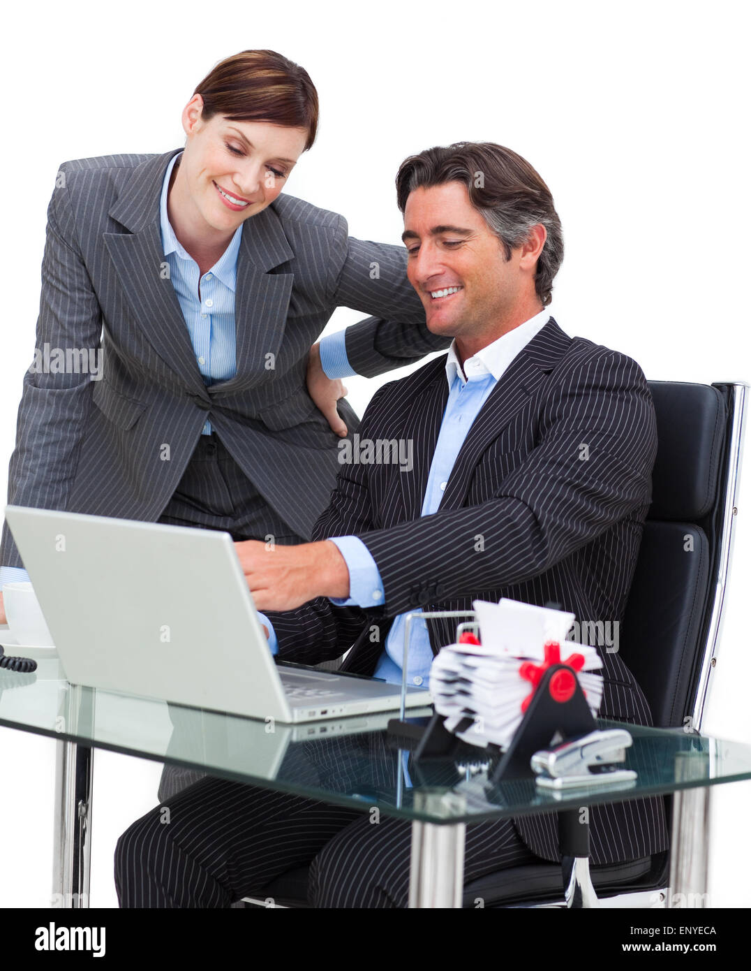 Assertive businessman showing something on computer to his colleague in ...