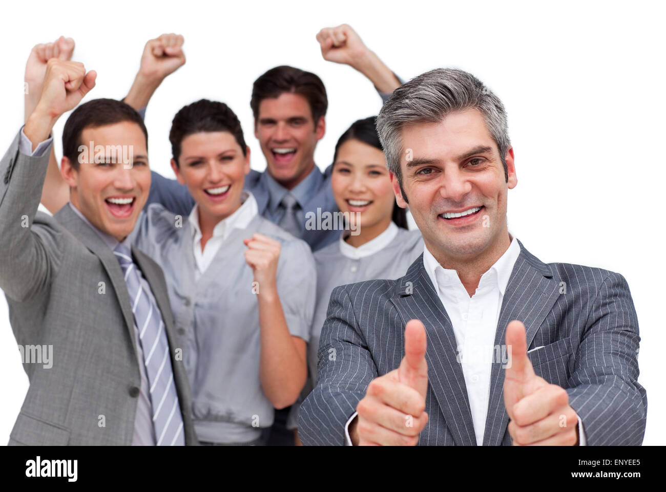 Happy manager with thumbs up standing with his team against a white ...