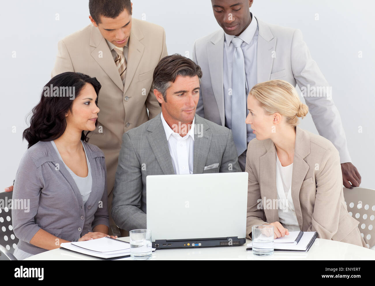 Multi-ethnic business team working in office together Stock Photo - Alamy