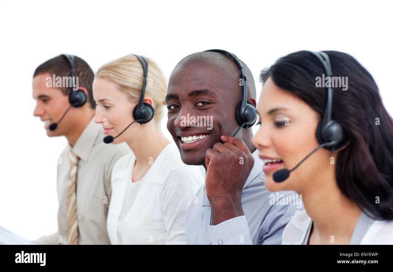 Attractive man and his team working in a call center against a white ...