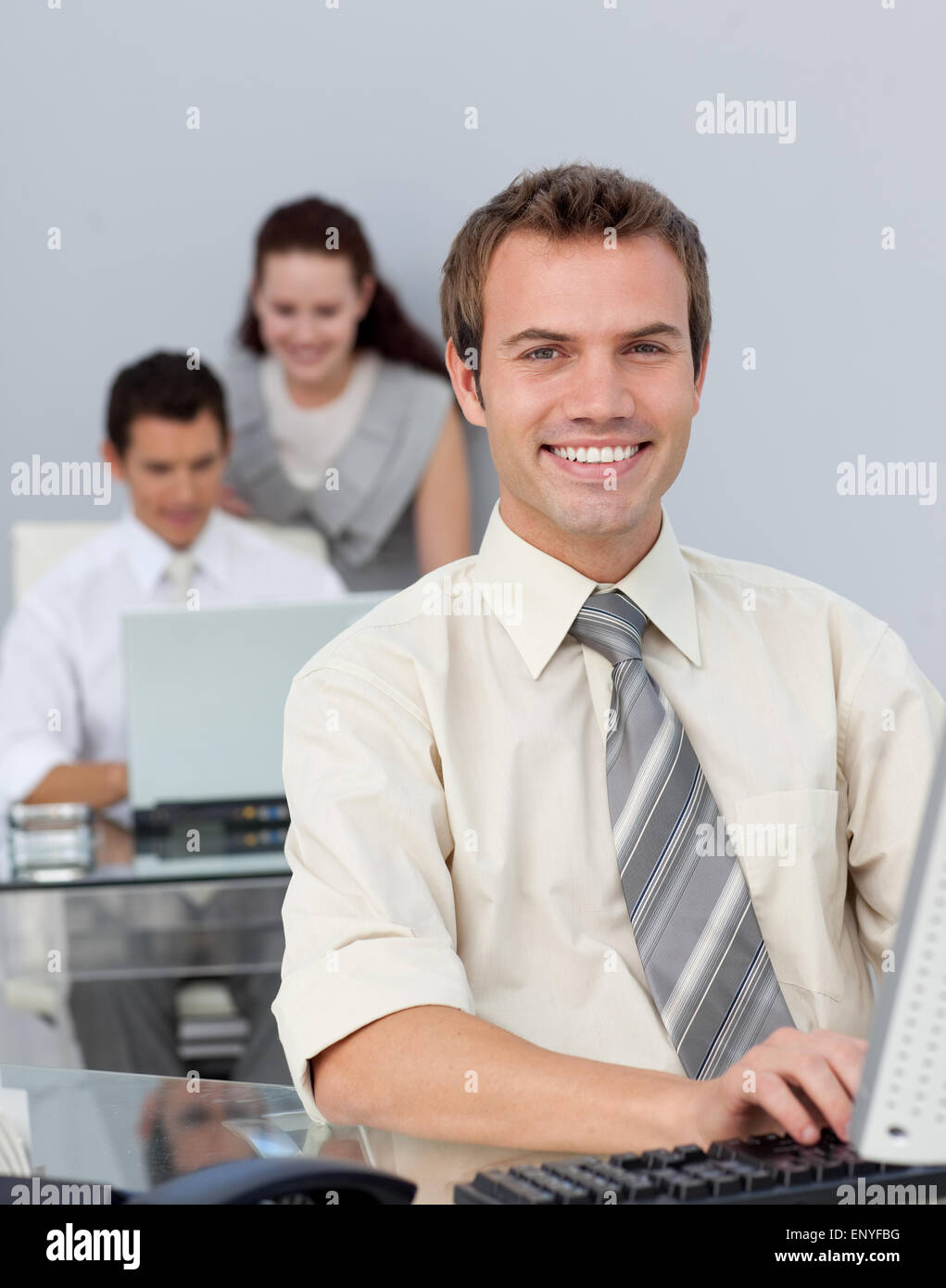 Attractive businessman working at his computer Stock Photo - Alamy