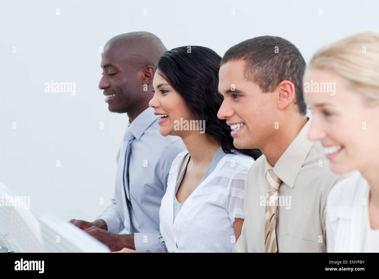 Multi-ethnic business team working in the office Stock Photo - Alamy