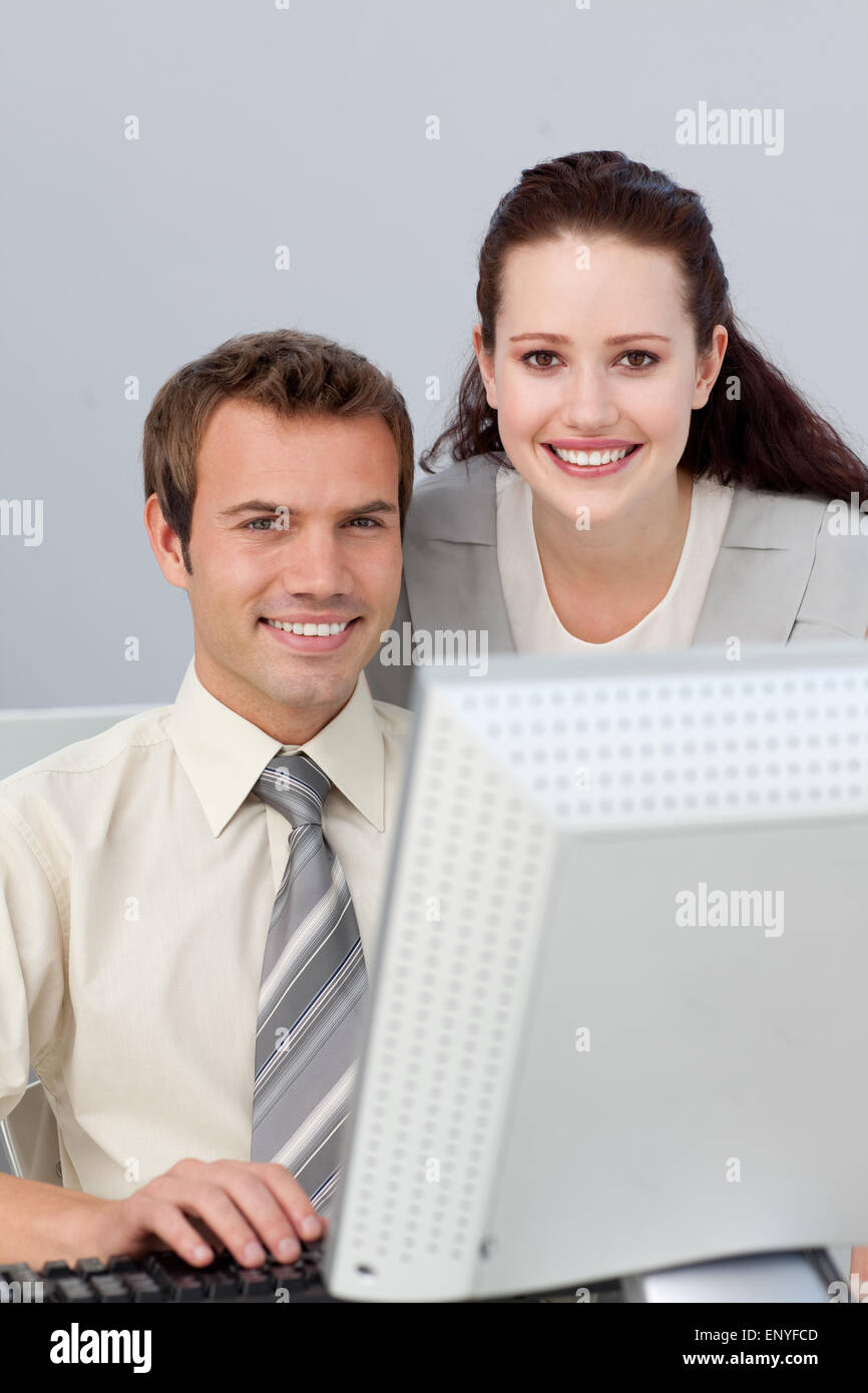 Smiling businesswoman helping her colleague Stock Photo - Alamy