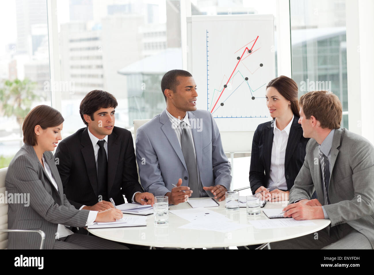 Business group studying sales report Stock Photo - Alamy