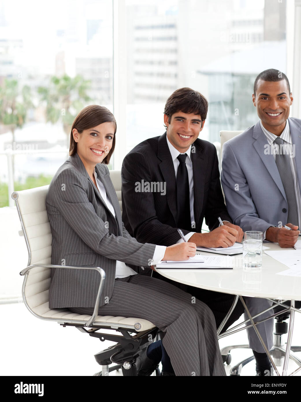 Three co-workers smiling at the camera Stock Photo - Alamy