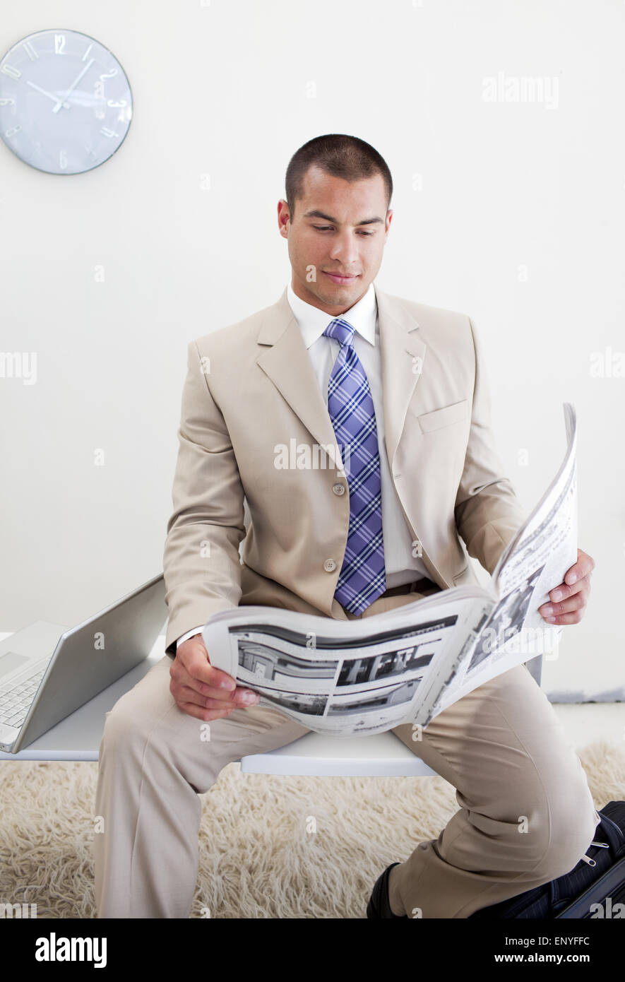 Confident manager reading a newspaper Stock Photo - Alamy