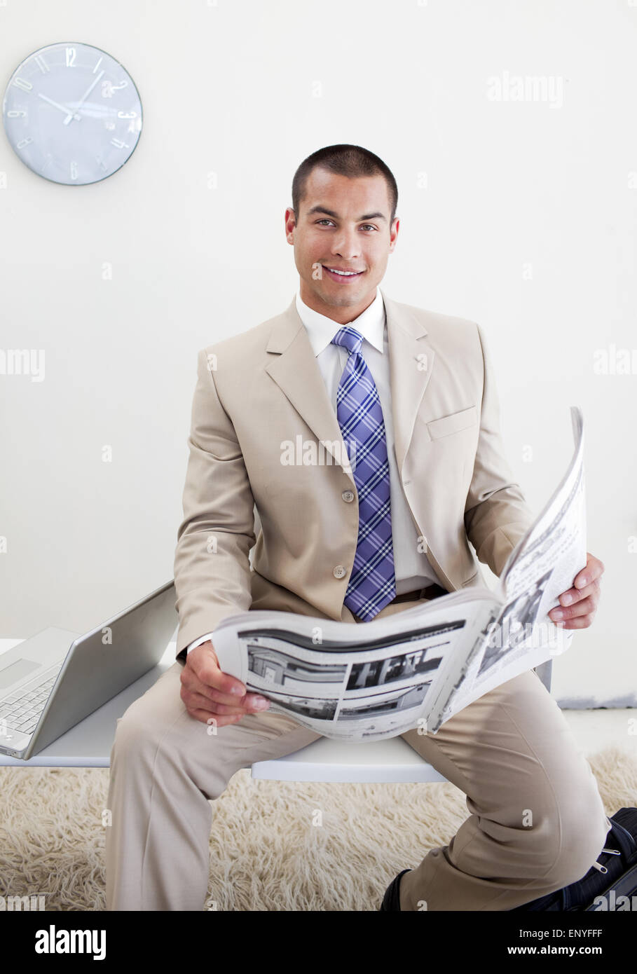Charming manager reading a newspaper Stock Photo - Alamy