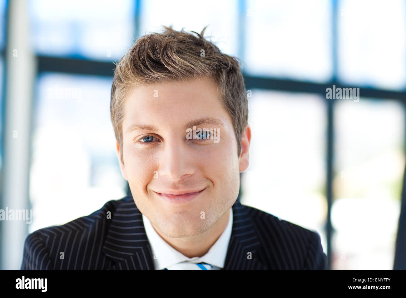 Young businessman smiling at the camera Stock Photo - Alamy