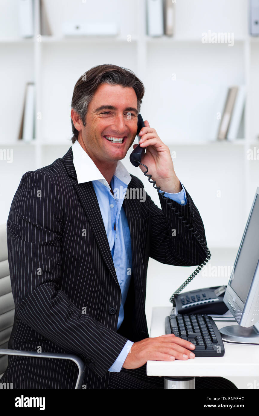 Attractive businessman making a phone call Stock Photo - Alamy
