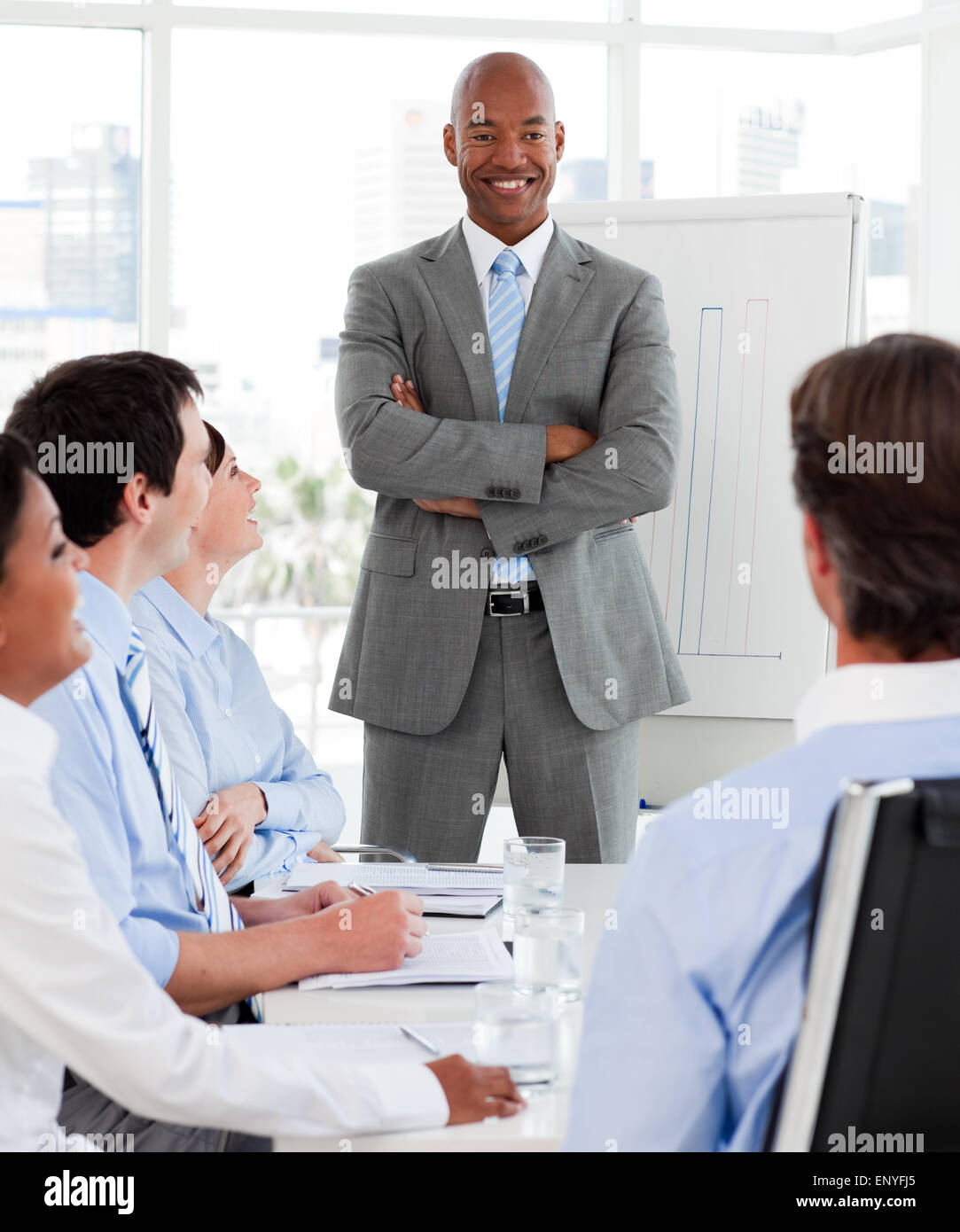 Confident manager reporting sales figures to his team Stock Photo - Alamy
