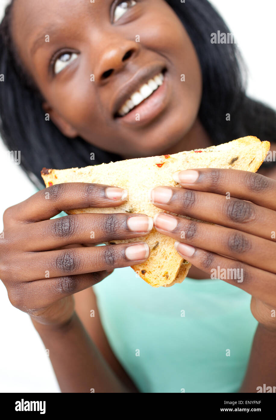 Smiling young woman eating a sandwich Stock Photo - Alamy