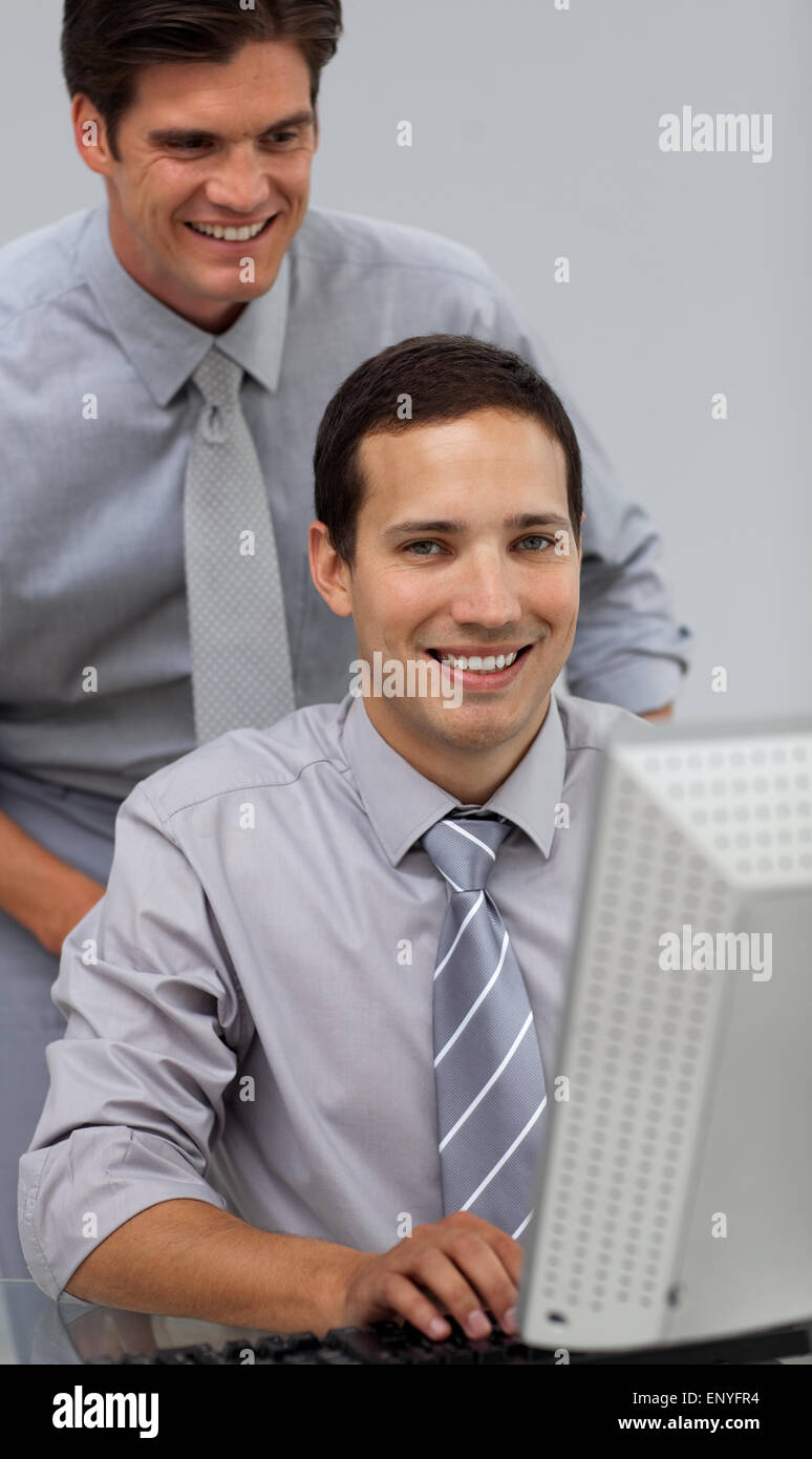 Smiling manager checking his employee's work Stock Photo - Alamy