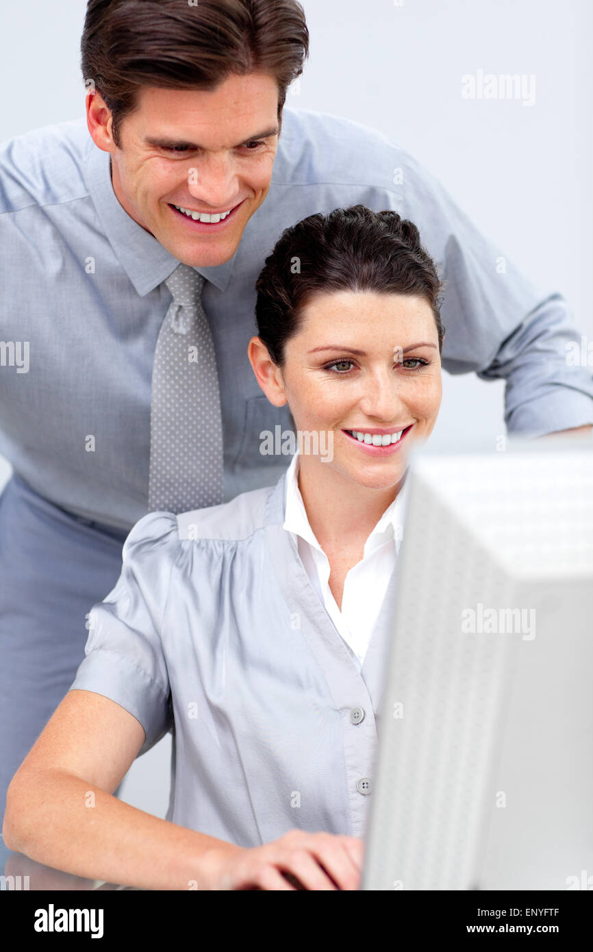 Confident business woman and her colleage working at a computer Stock ...