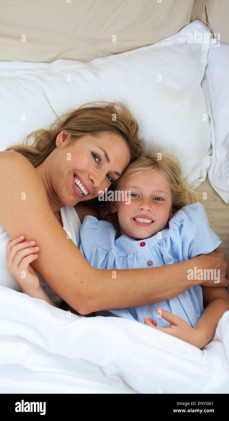 Attractive mother hugging her daughter Stock Photo - Alamy