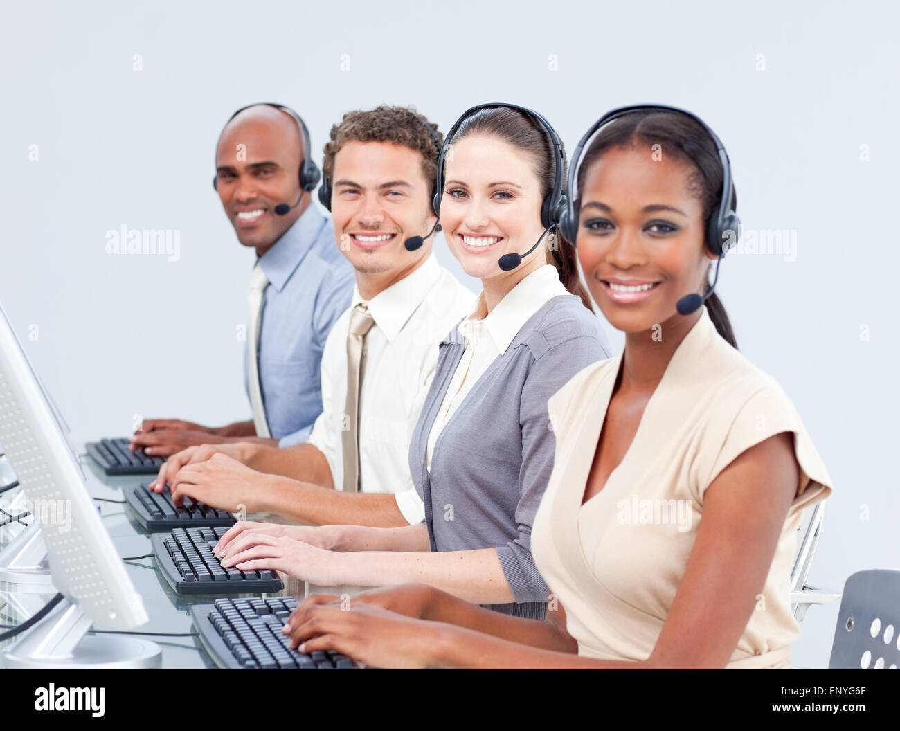 Multi-ethnic customer service representatives using headset Stock Photo - Alamy