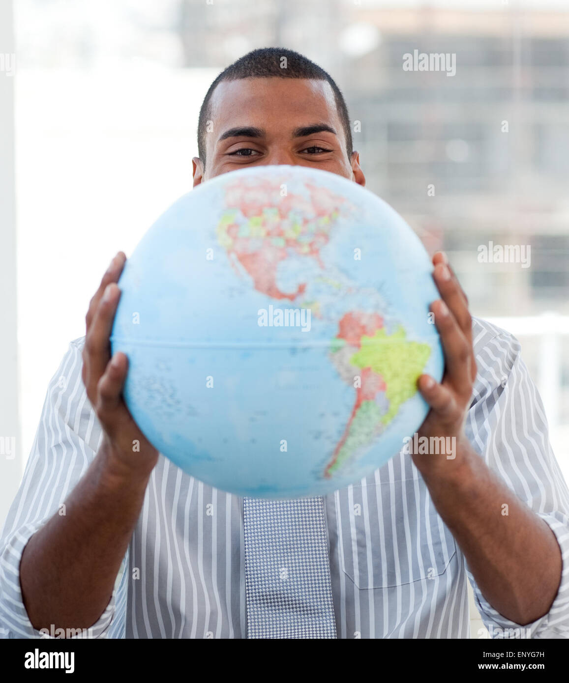 Fortunate businessman holding a terrestrial globe Stock Photo - Alamy