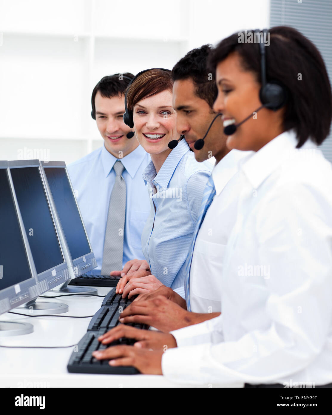 Young business people with headsets on working in call center Stock ...