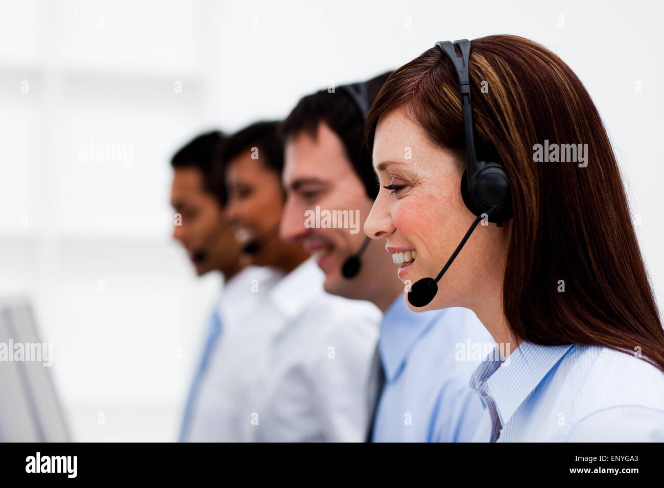 Multi-ethnic customer service agents with headset on Stock Photo - Alamy