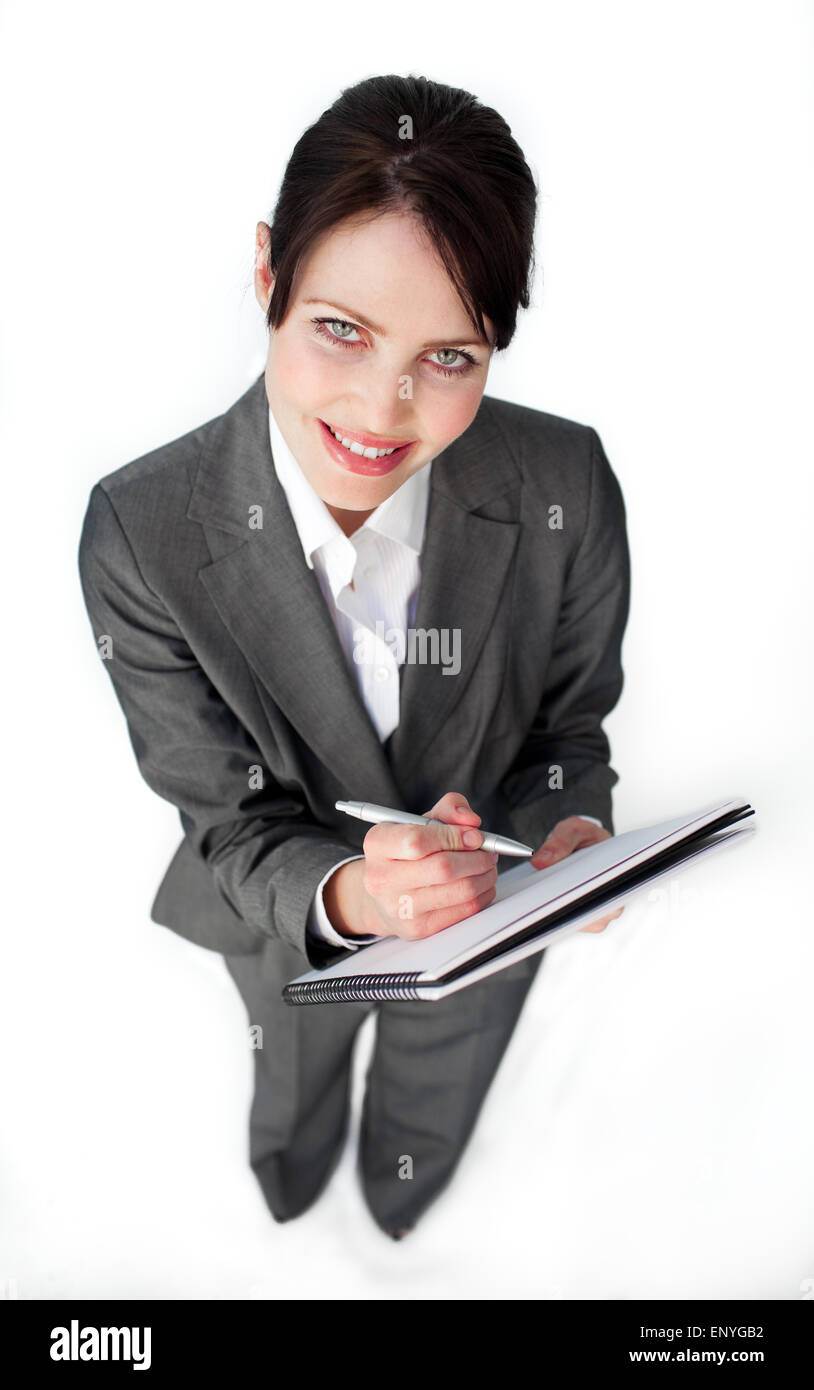 Attractive businesswoman taking notes against a white background Stock ...
