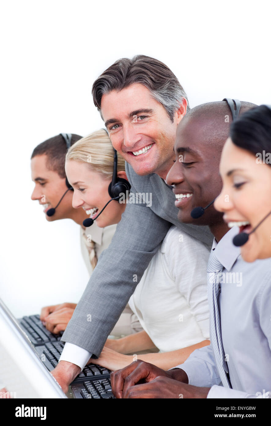 Mature manager and his team working in a call center against a white ...