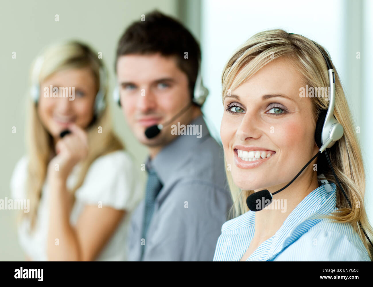 Young businesspeople smiling at the camera with headsets Stock Photo ...