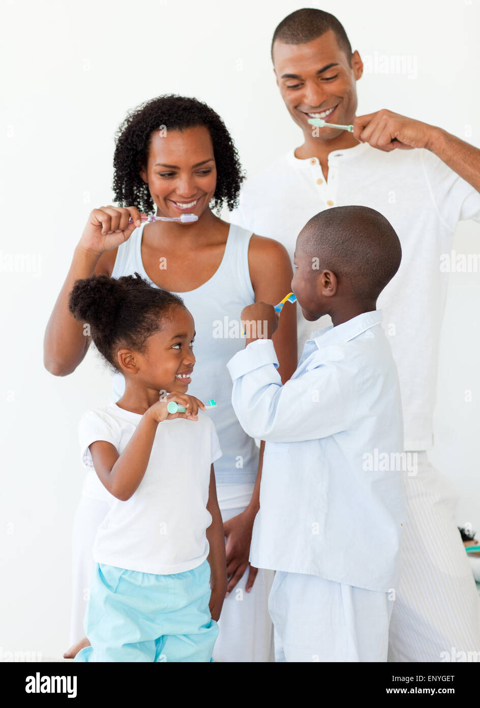 Portrait of a happy family brushing their teeth together Stock Photo ...