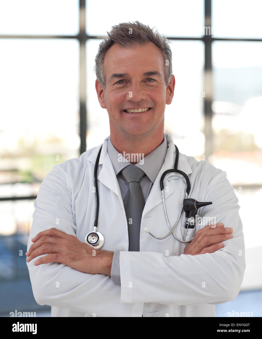 Smiling doctor with folded arms Stock Photo - Alamy