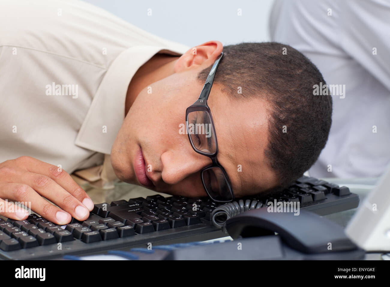 Young businessman sleeping on the keyboard Stock Photo - Alamy