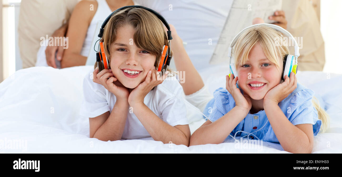 Smiling siblings listening music hi-res stock photography and images ...
