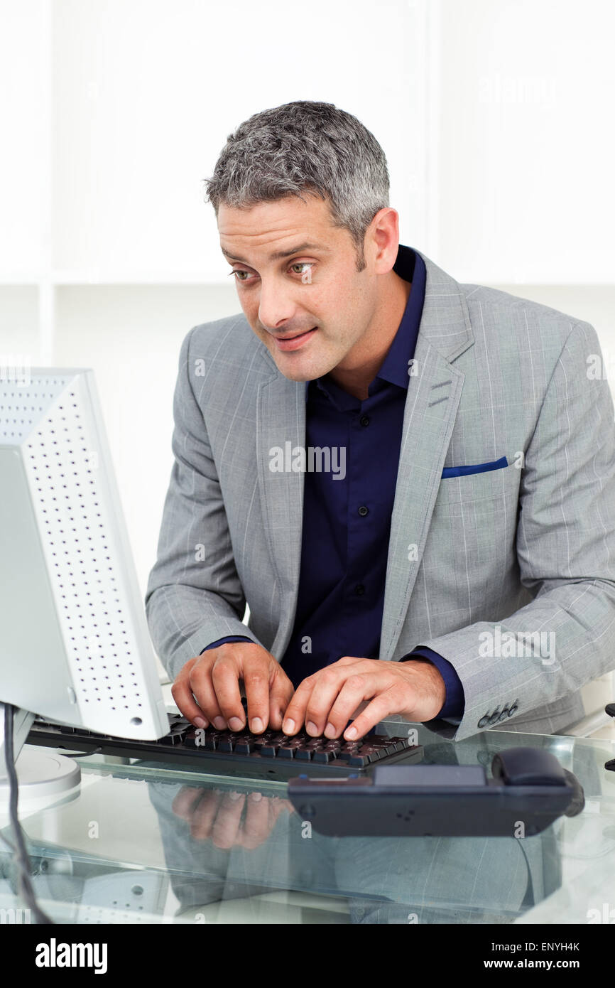 Concentrated businessman working at a computer Stock Photo - Alamy