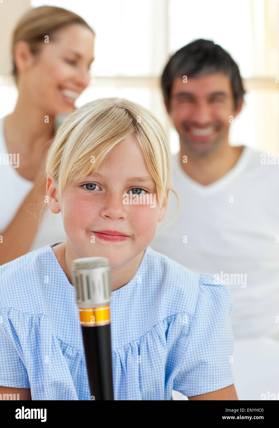 Blond child singing with a microphone Stock Photo - Alamy