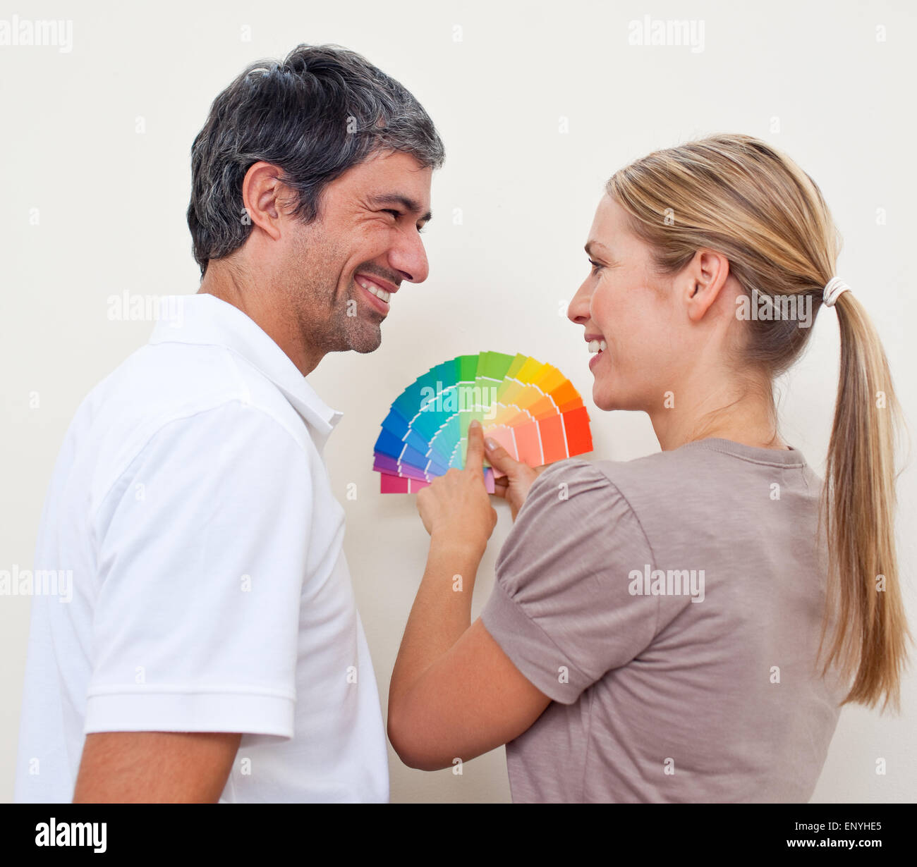 Couple with color samples to paint their new appartment Stock Photo - Alamy