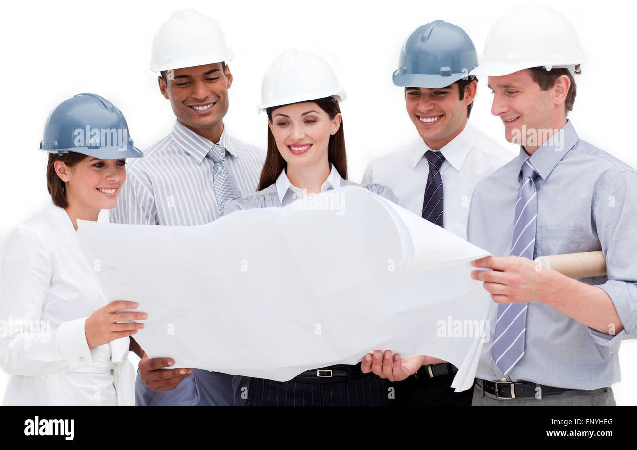 Multi-ethnic group of architects wearing hardhats against a white ...
