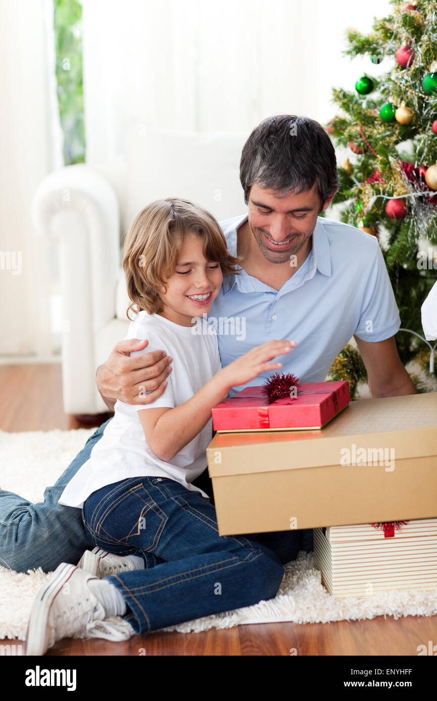 Happy father and his son holding Christmas presents Stock Photo - Alamy