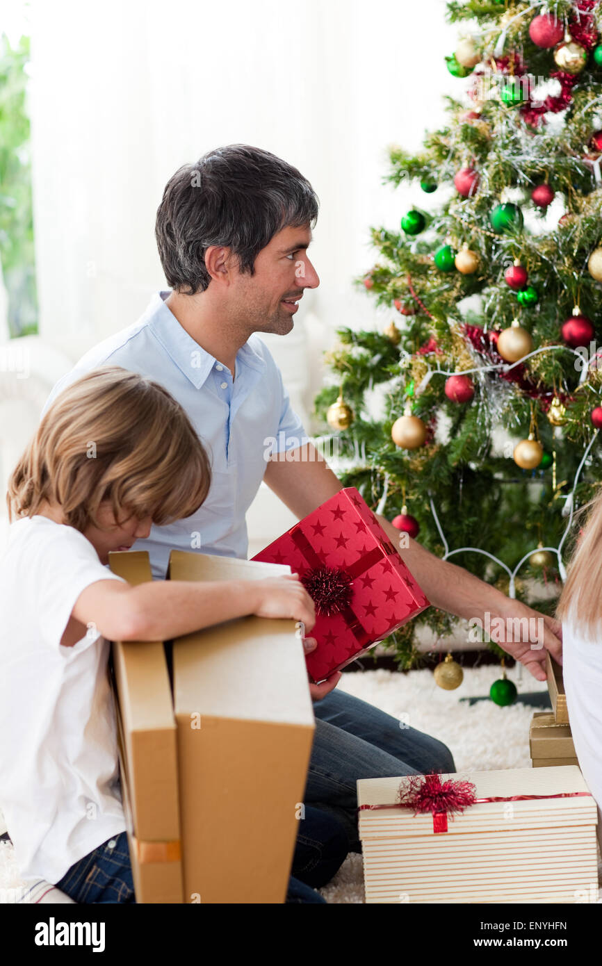 Father and his boy opening Christmas presents Stock Photo - Alamy