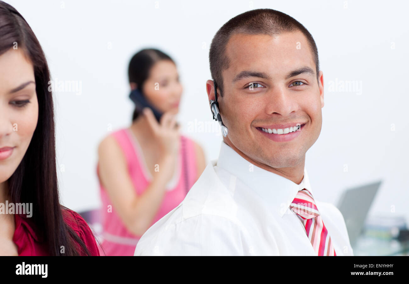 Portrait of a man with an hands-free set and his team Stock Photo - Alamy