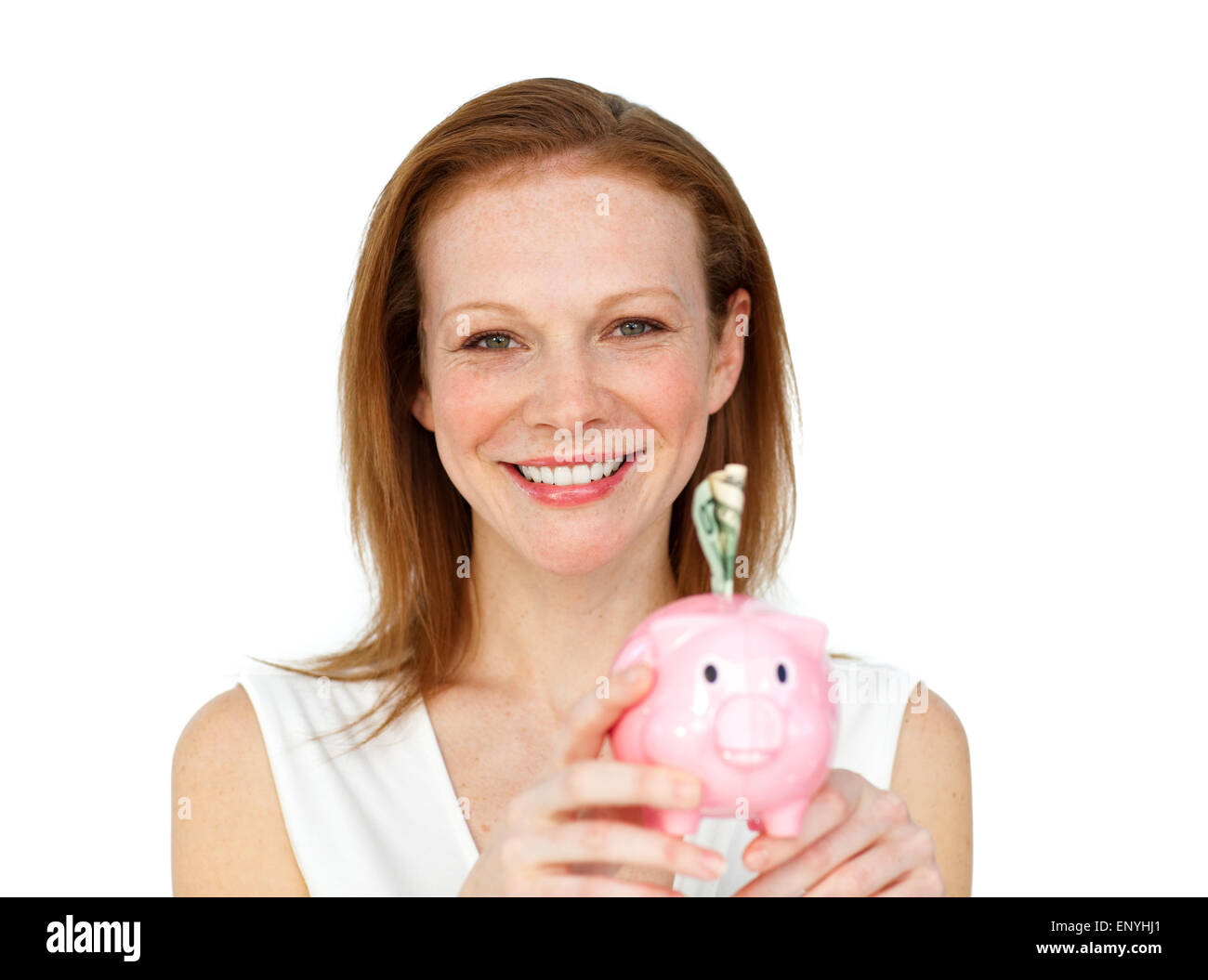 Smiling businesswoman saving money in a piggybank Stock Photo - Alamy