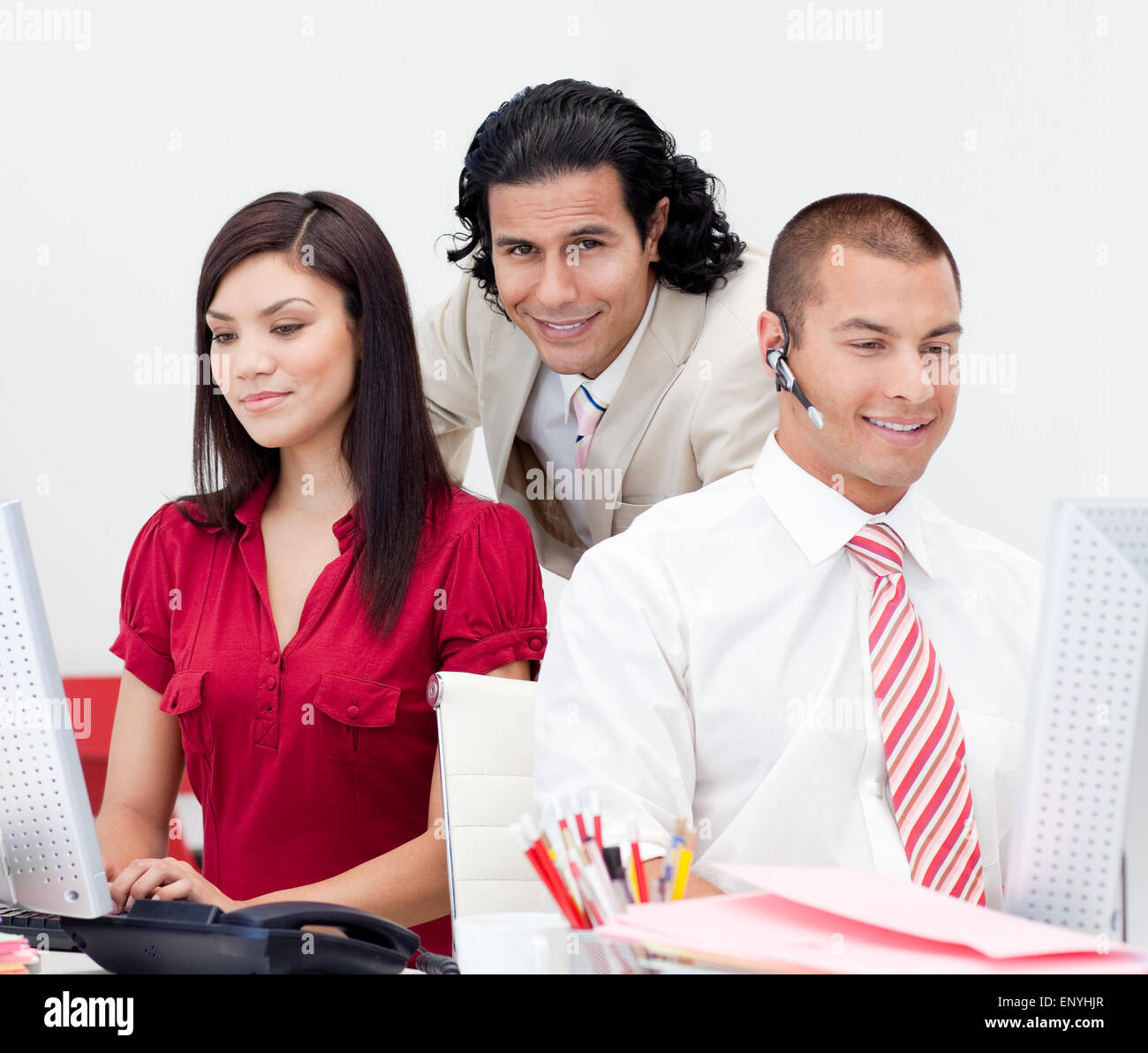 Attractive manager checking his team work Stock Photo - Alamy
