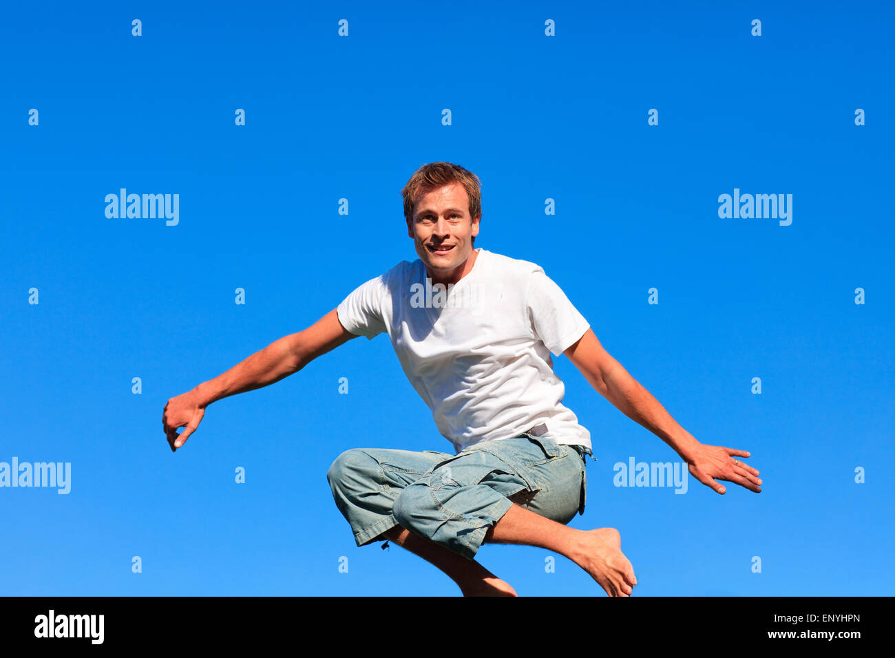 Attractive Man jumping in the air outdoor Stock Photo - Alamy