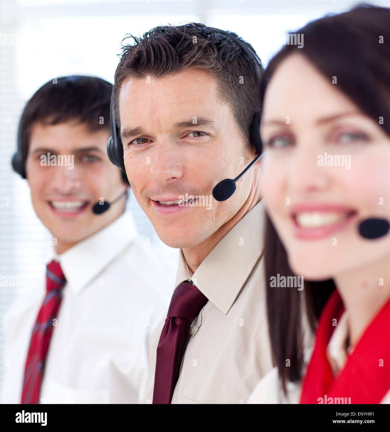 Customer service agents with headsets on Stock Photo - Alamy
