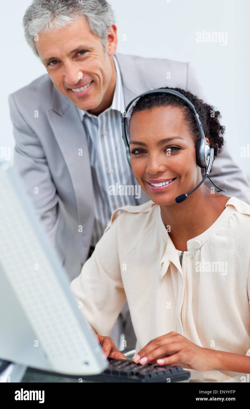 Smiling business people working at a computer Stock Photo - Alamy