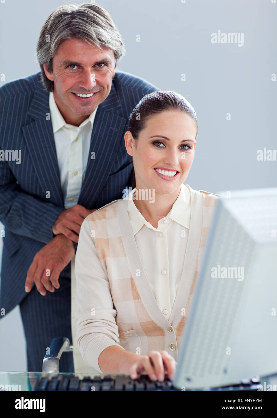 Mature manager helping his colleague work at a computer Stock Photo - Alamy