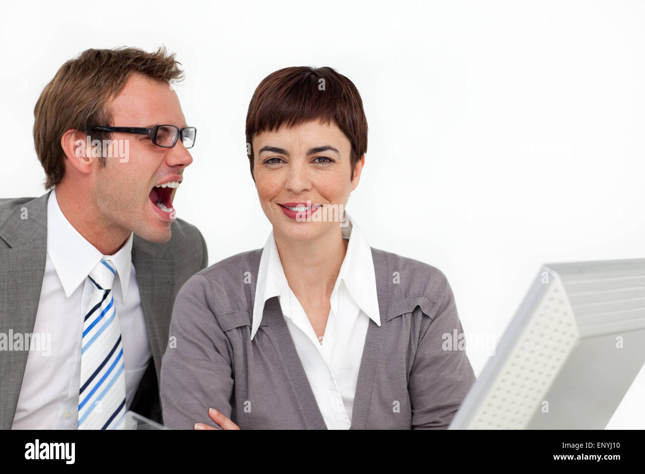 Young businessman shouting into his colleague's ear Stock Photo - Alamy