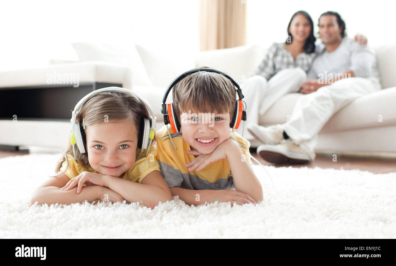 Adorable siblings listening music with headphones Stock Photo - Alamy