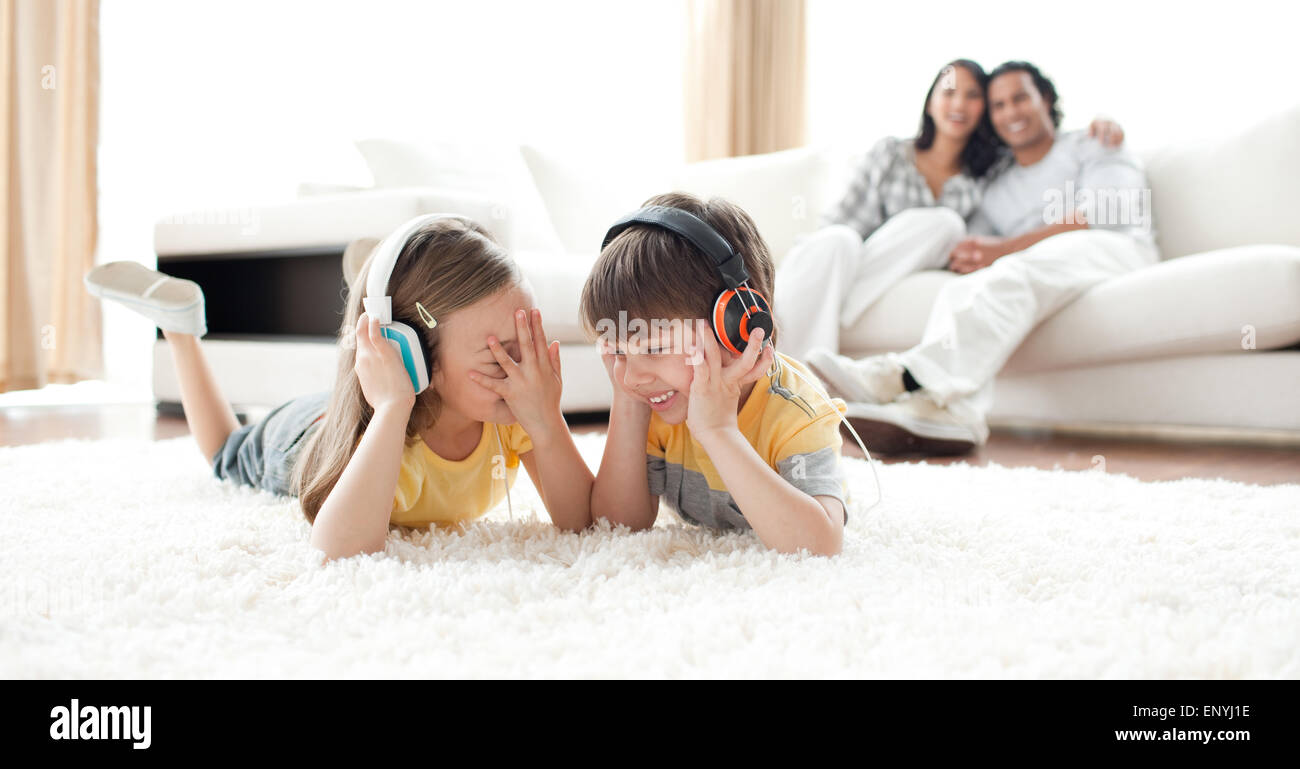 Laughing children listening music with headphones Stock Photo - Alamy